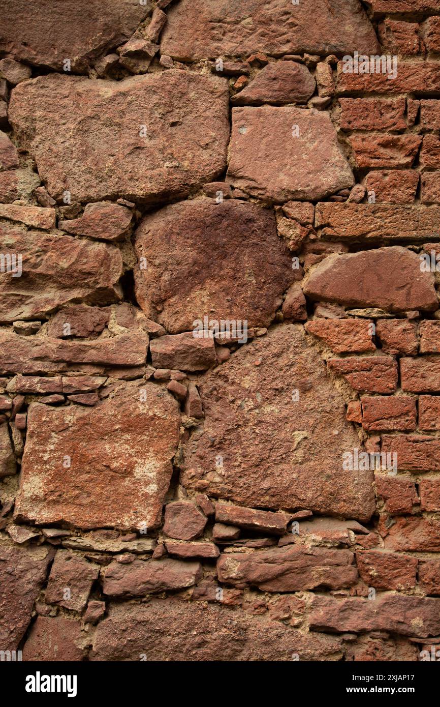 Close up. Old red wall made of various sizes stone and bricks ...