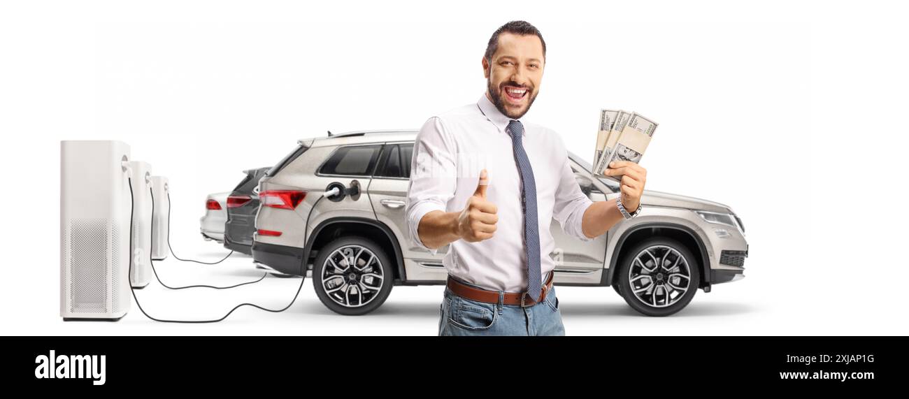Happy businessman holding money in front of ev cars at a charging ...