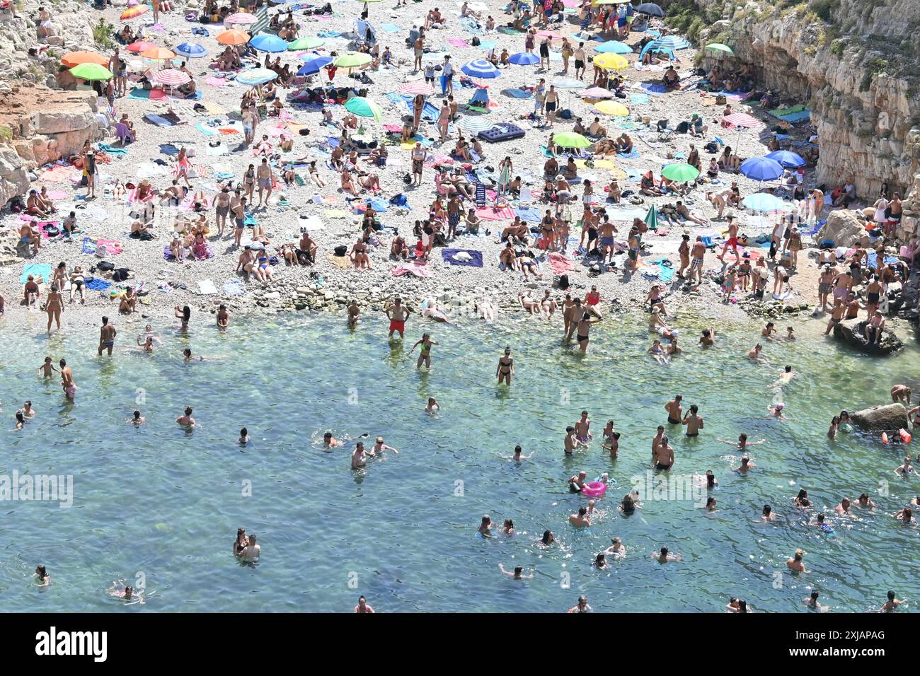 People on the beach in Polignano a Mare, a small coastal town in Apulia ...