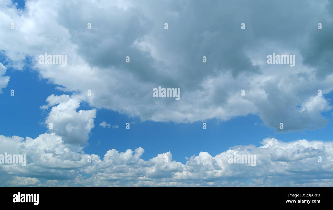 Time lapse. White clouds float across the blue sky. Puffy fluffy soft clouds Stock Photo - Alamy