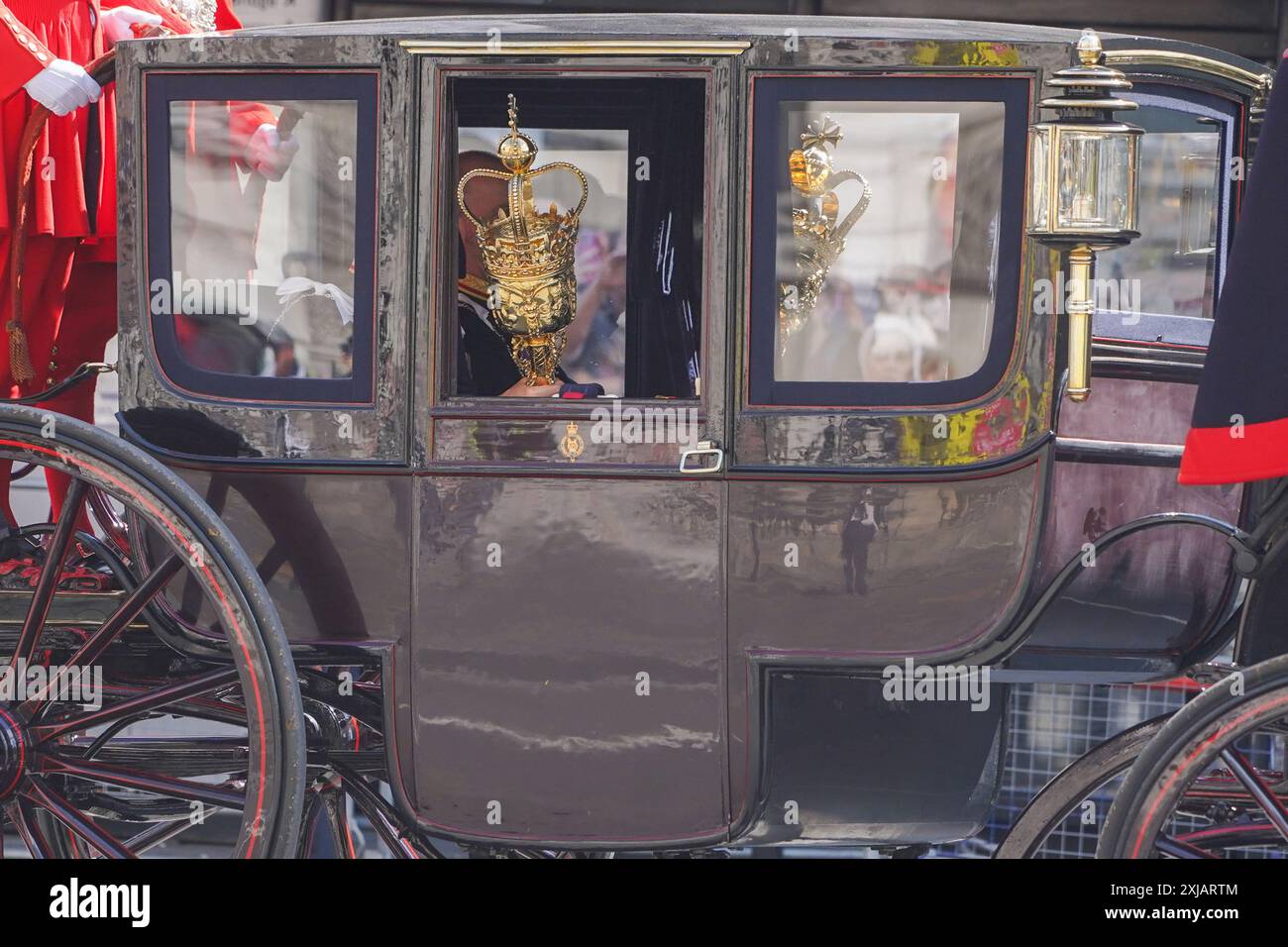 The ceremonial mace protudes from a carriage window for the State ...