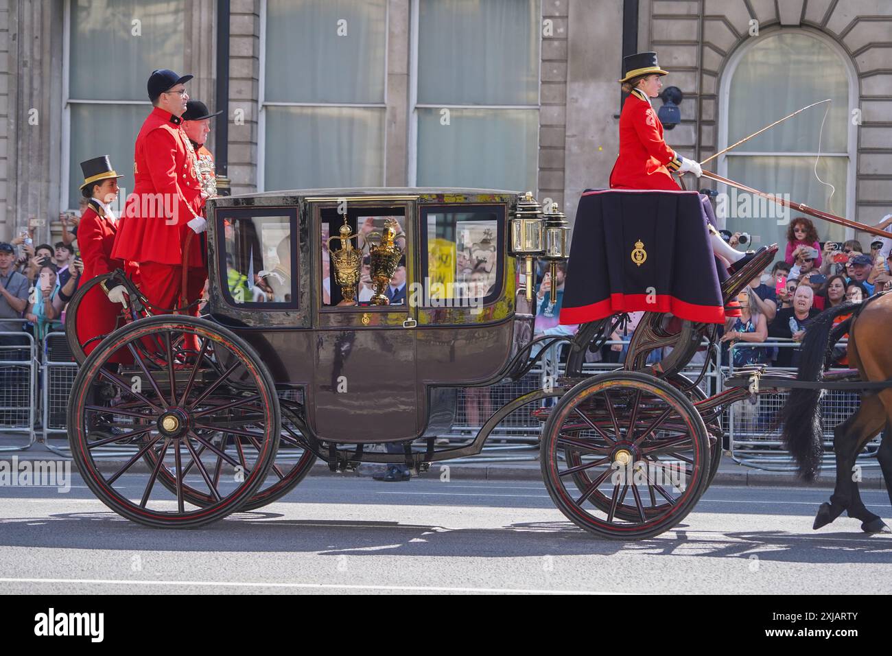 The ceremonial mace protudes from a carriage window for the State ...