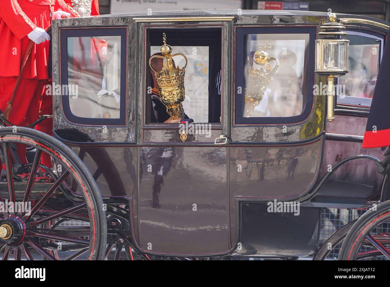 The ceremonial mace protudes from a carriage window for the State ...