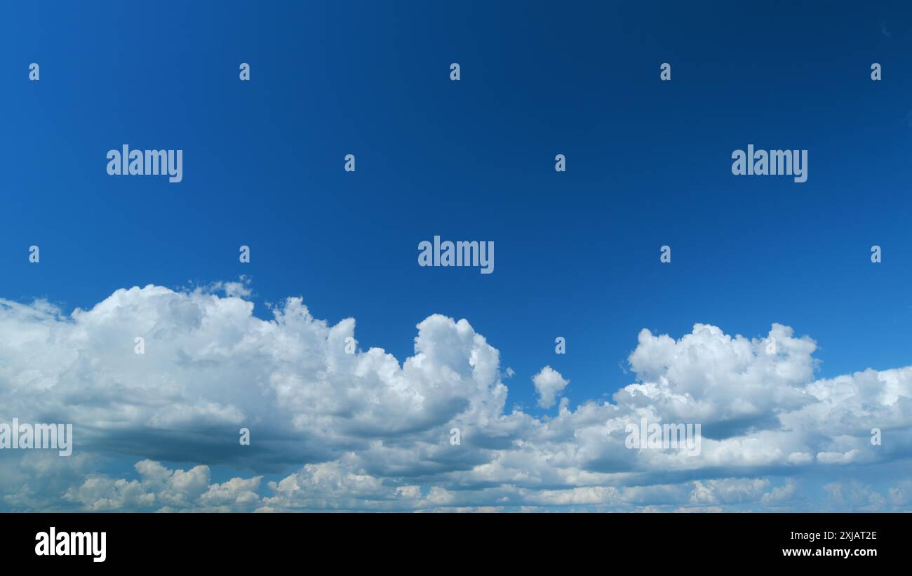 Time lapse. White clouds float across the blue sky. Puffy fluffy soft ...