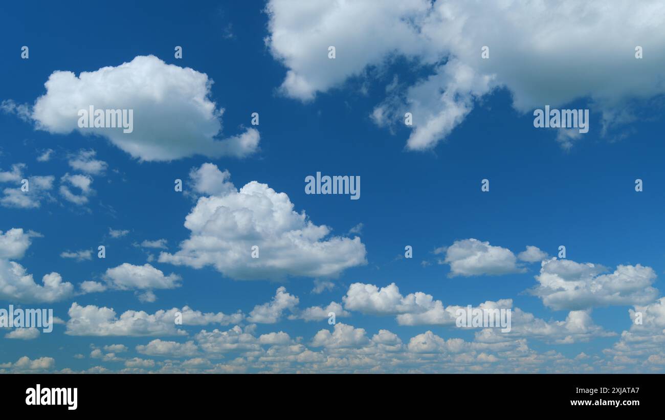 Time lapse. Clouds formation running across the blue sky. White puffy ...