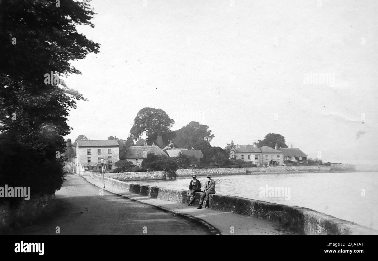 Two people sitting on a wall possibly beside the River Teign, and the ...
