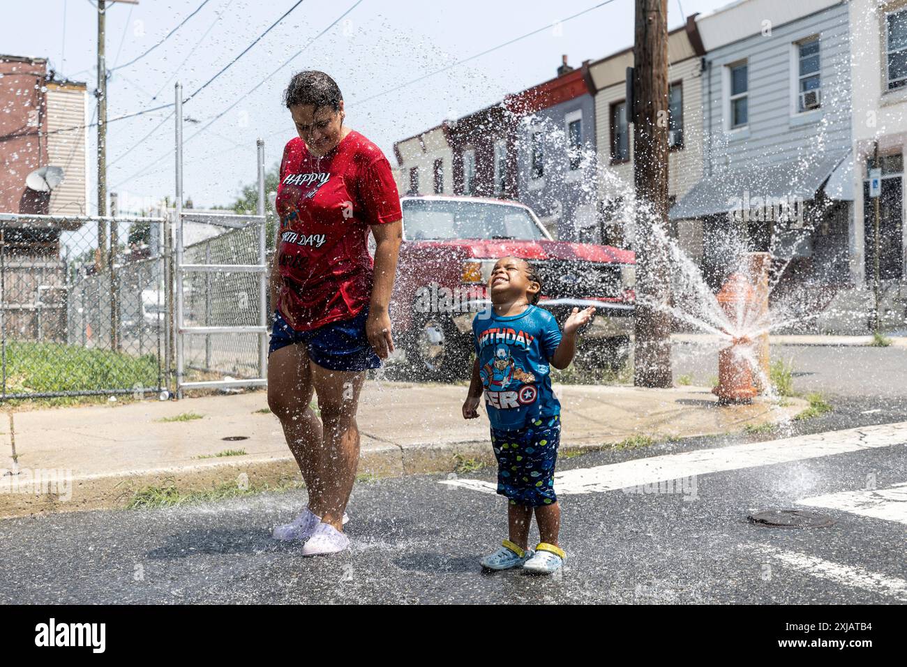 Alexandra Figueroa, 33, is cooling off in the summer heat with her son ...