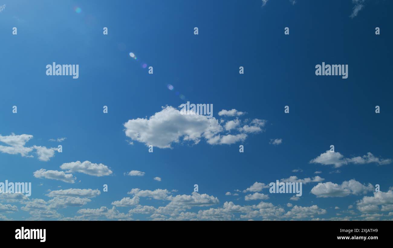 Time lapse. Fluffy curly rolling cloud in windy Summer weather. White ...