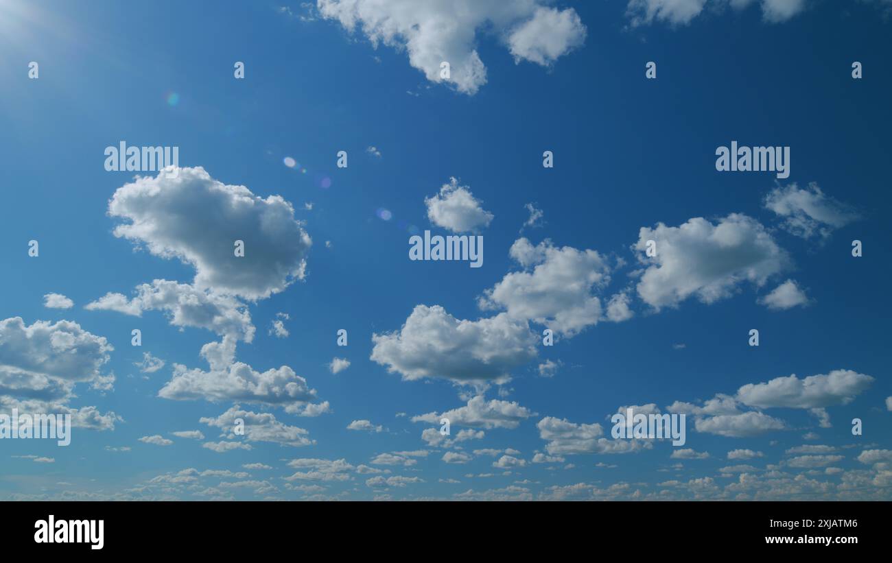 Time lapse. Fluffy curly rolling cloud in windy weather. Blue sky white ...