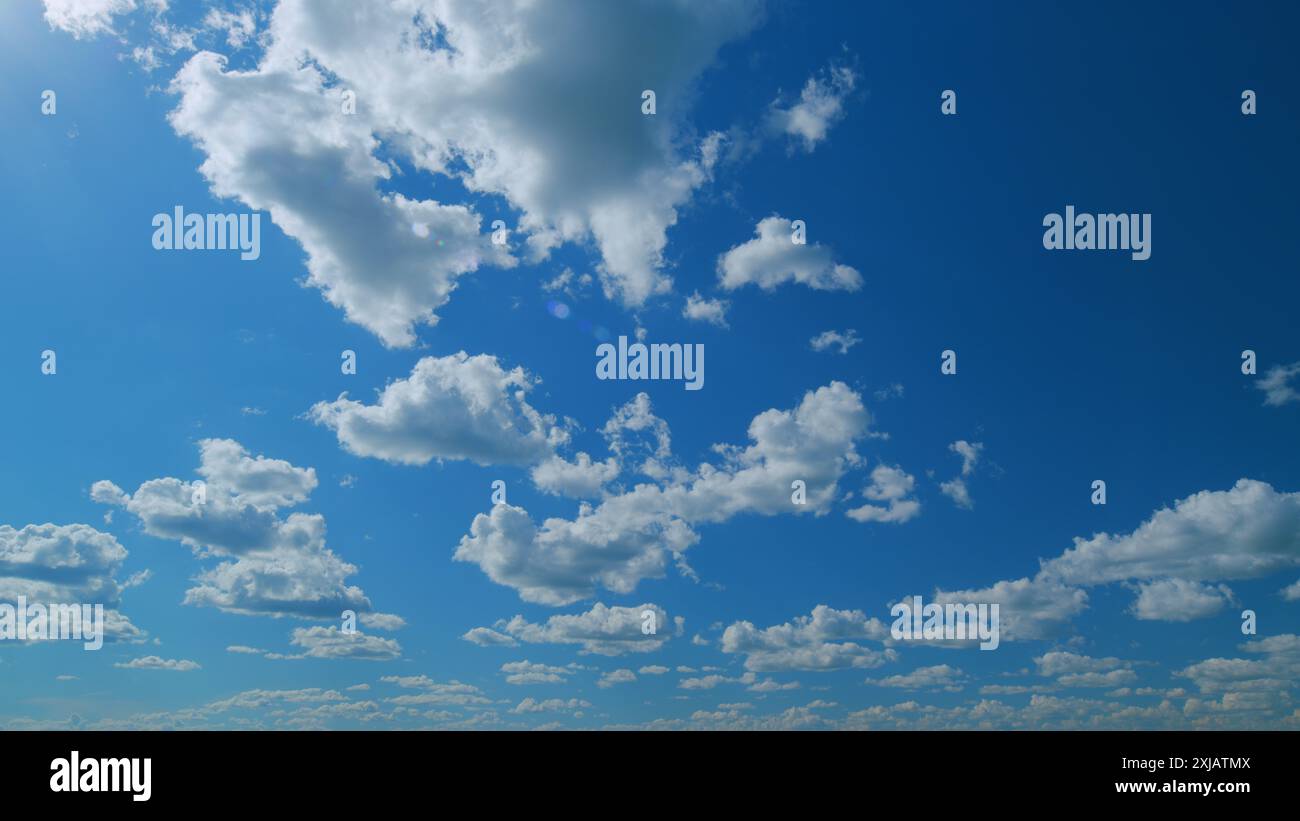 Time lapse. White clouds float across the blue sky. Puffy fluffy soft ...