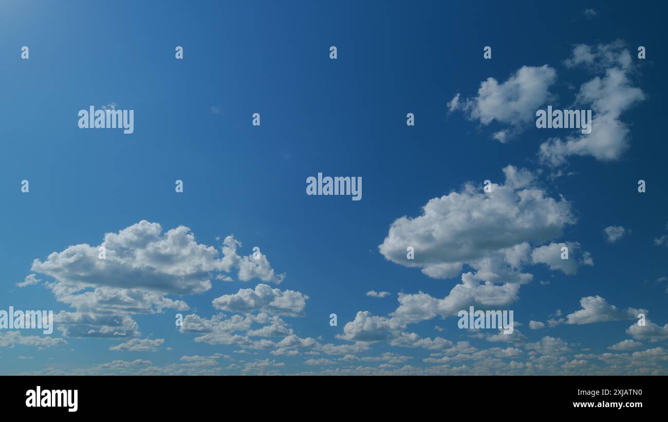 Time lapse. Puffy fluffy white clouds. Forming cloud moving with blue ...