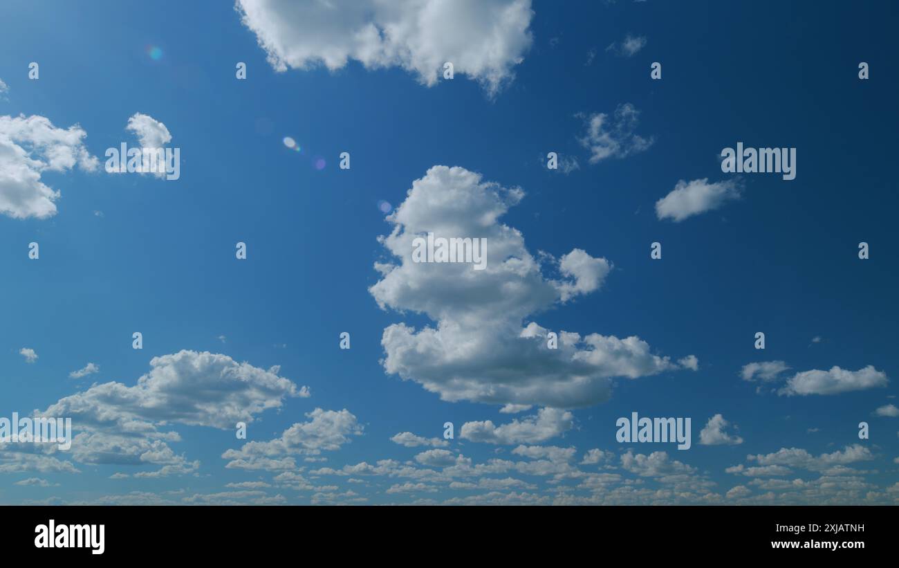 Time lapse. Clouds formation running across the blue sky. White puffy ...
