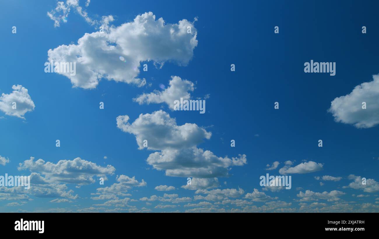 Time lapse. Puffy fluffy white cloud. Summer blue sky background Stock ...