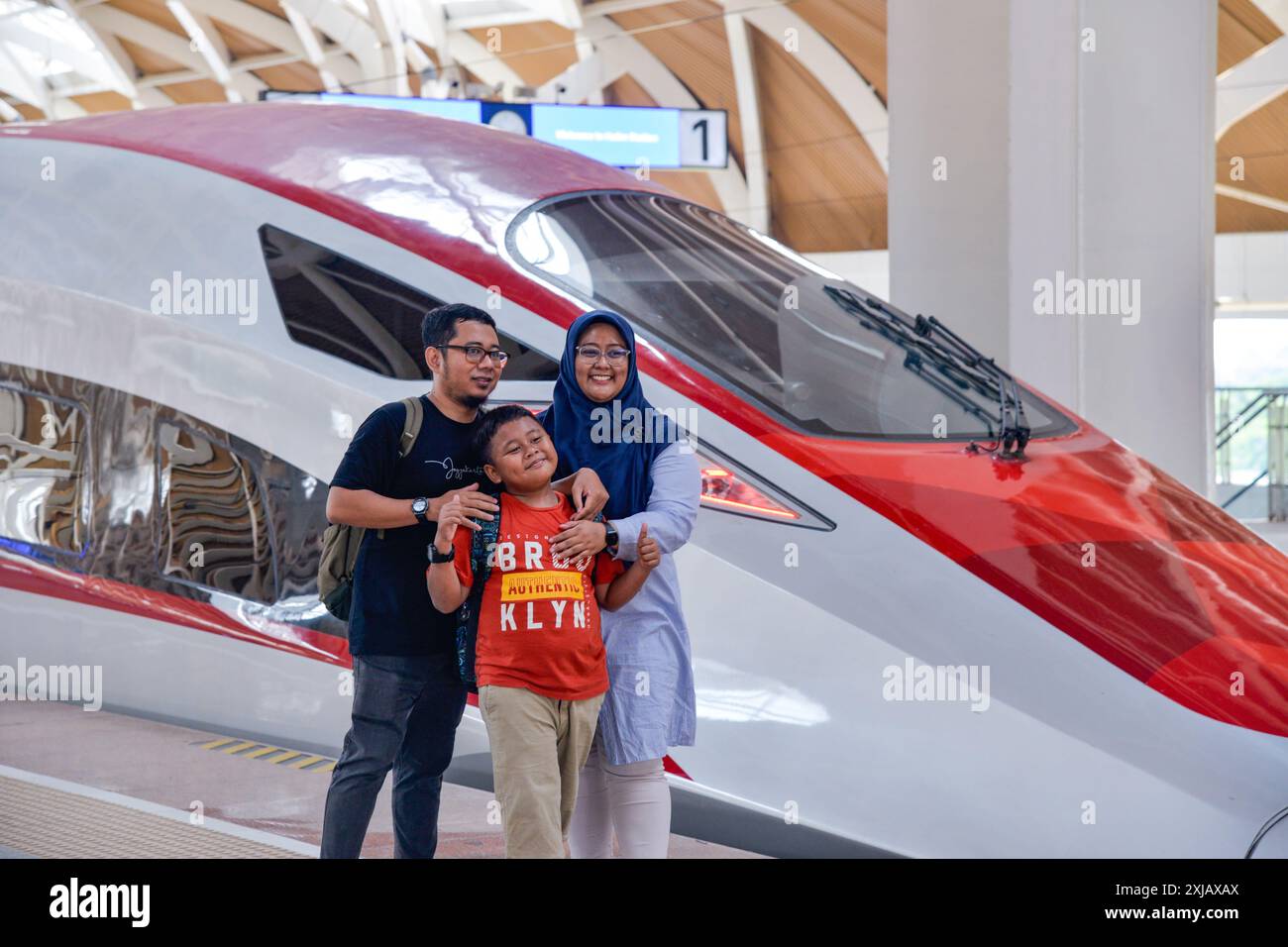 Beijing, Indonesia. 17th Apr, 2024. Passengers pose for photos with a high-speed electrical ...