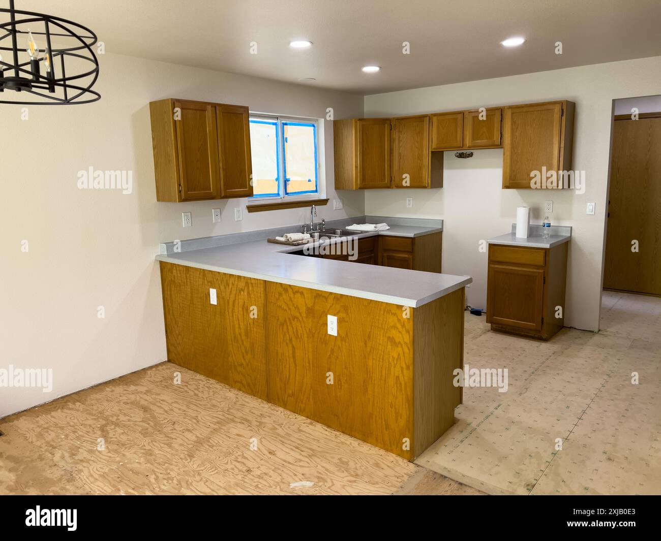Kitchen Under Renovation with Wooden Cabinets and Unfinished Floor ...