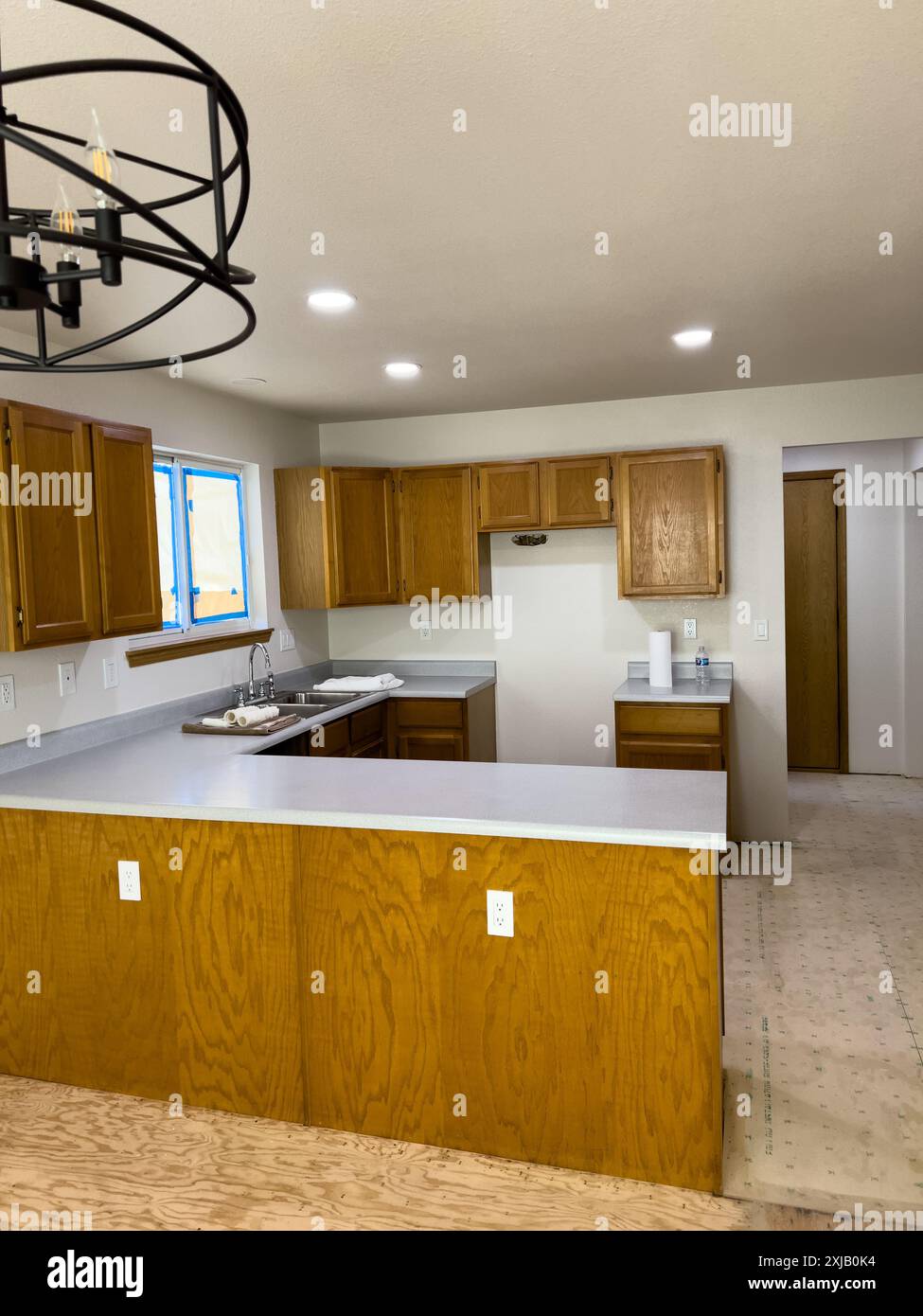 Kitchen Under Renovation with Wooden Cabinets and Unfinished Floor ...