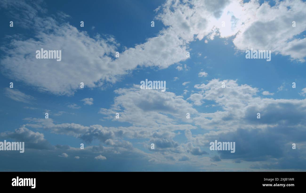 Time lapse. Beautiful blue sky cloudy behind shining sun rays and ...