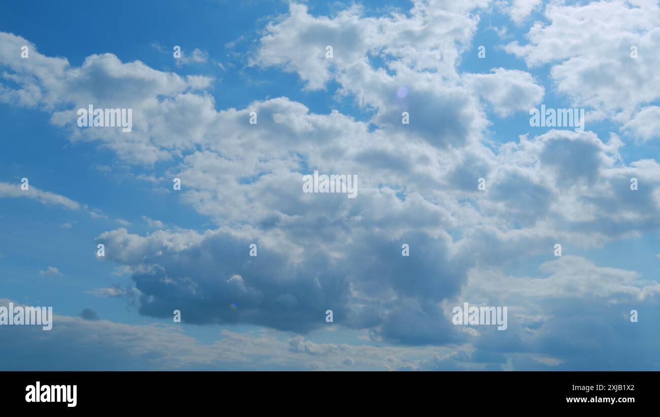 Time lapse. Rays of sun through clouds. Blue sky with cloudscape ...