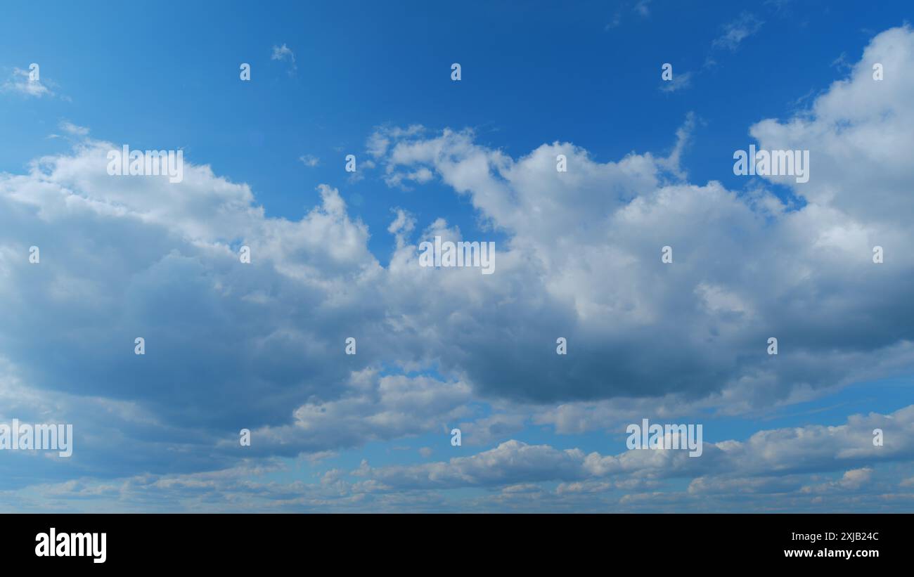 Time lapse. White puffy clouds forming on summer blue sky. Dark grey storm clouds Stock Photo ...