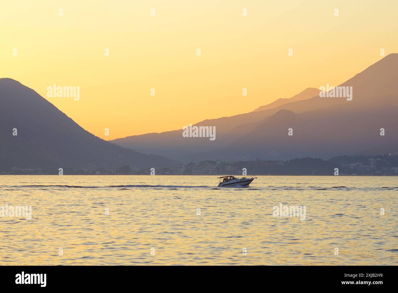Evening seascape with a boat: a view of a boat sailing on the sea ...