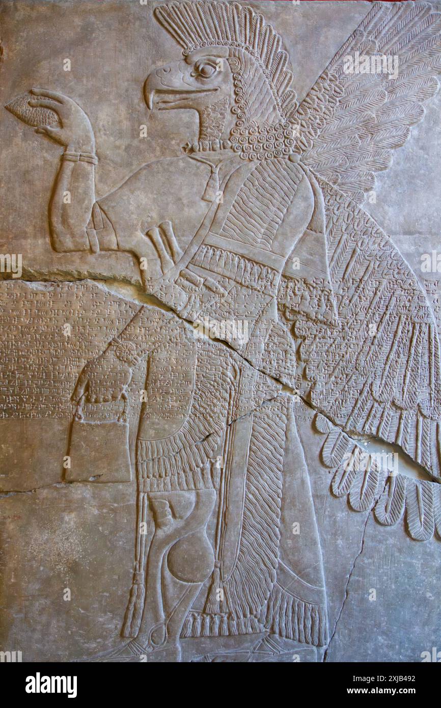 Alabaster relief of eagle-headed winged Apkallu holding a bucket and ...