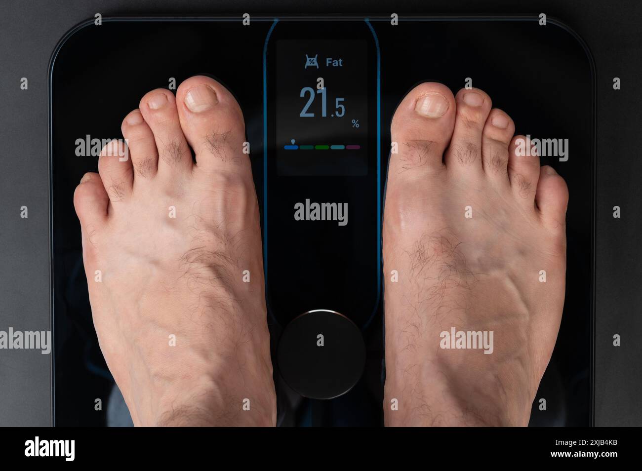 Checking fat body level with electronic scale standing on weight Stock ...