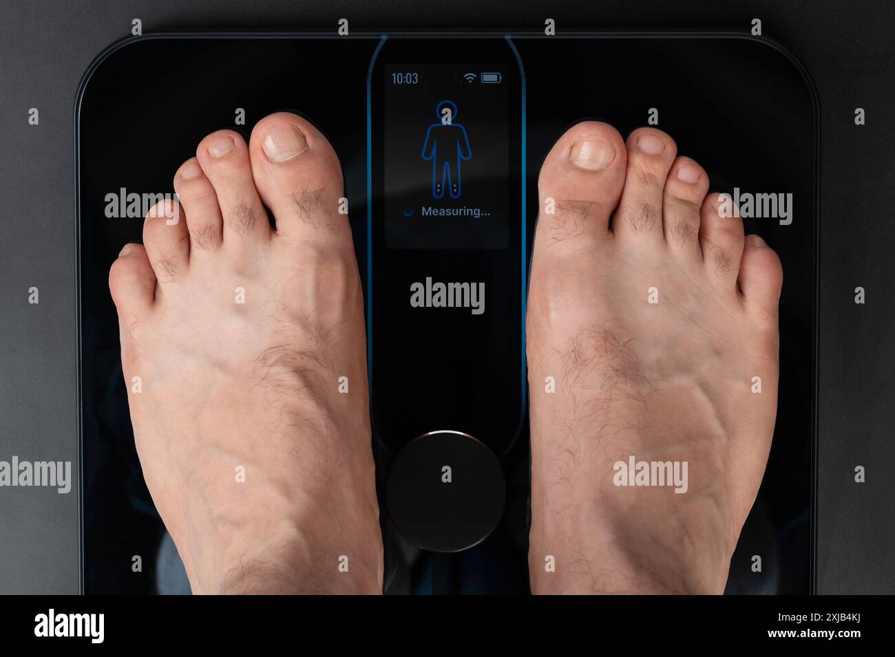 Measuring human body parameters with electronic scale Stock Photo - Alamy