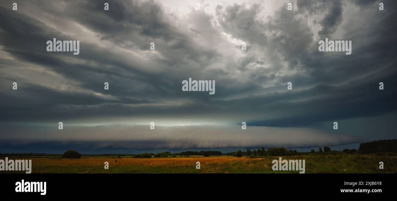 Supercell cloud with distant lightning illuminating the storm structure ...