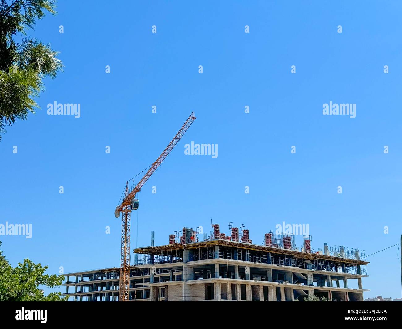 Hoisting crane and building activity Stock Photo - Alamy