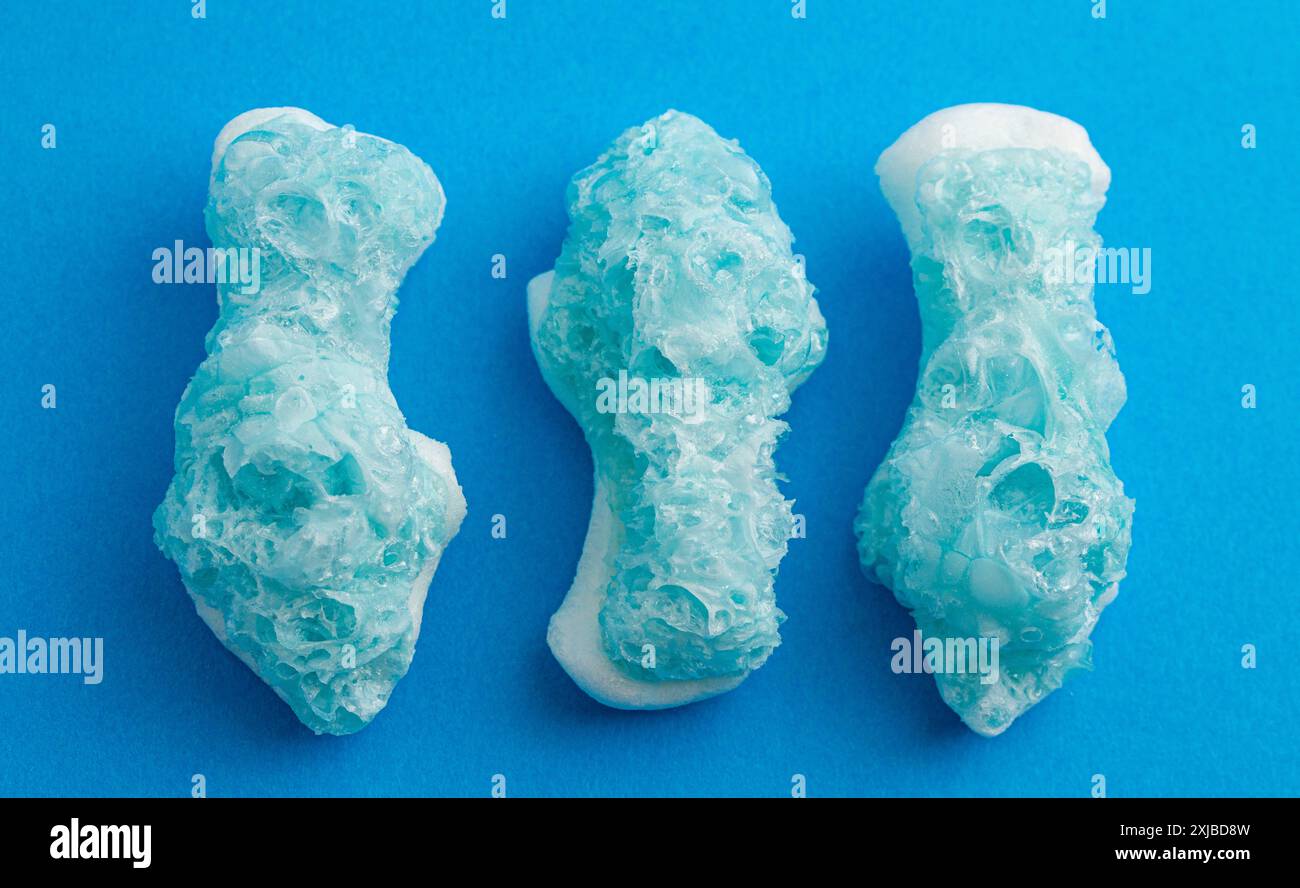Freeze Dried Gummy Shaped Sharks on a Blue Background Stock Photo - Alamy