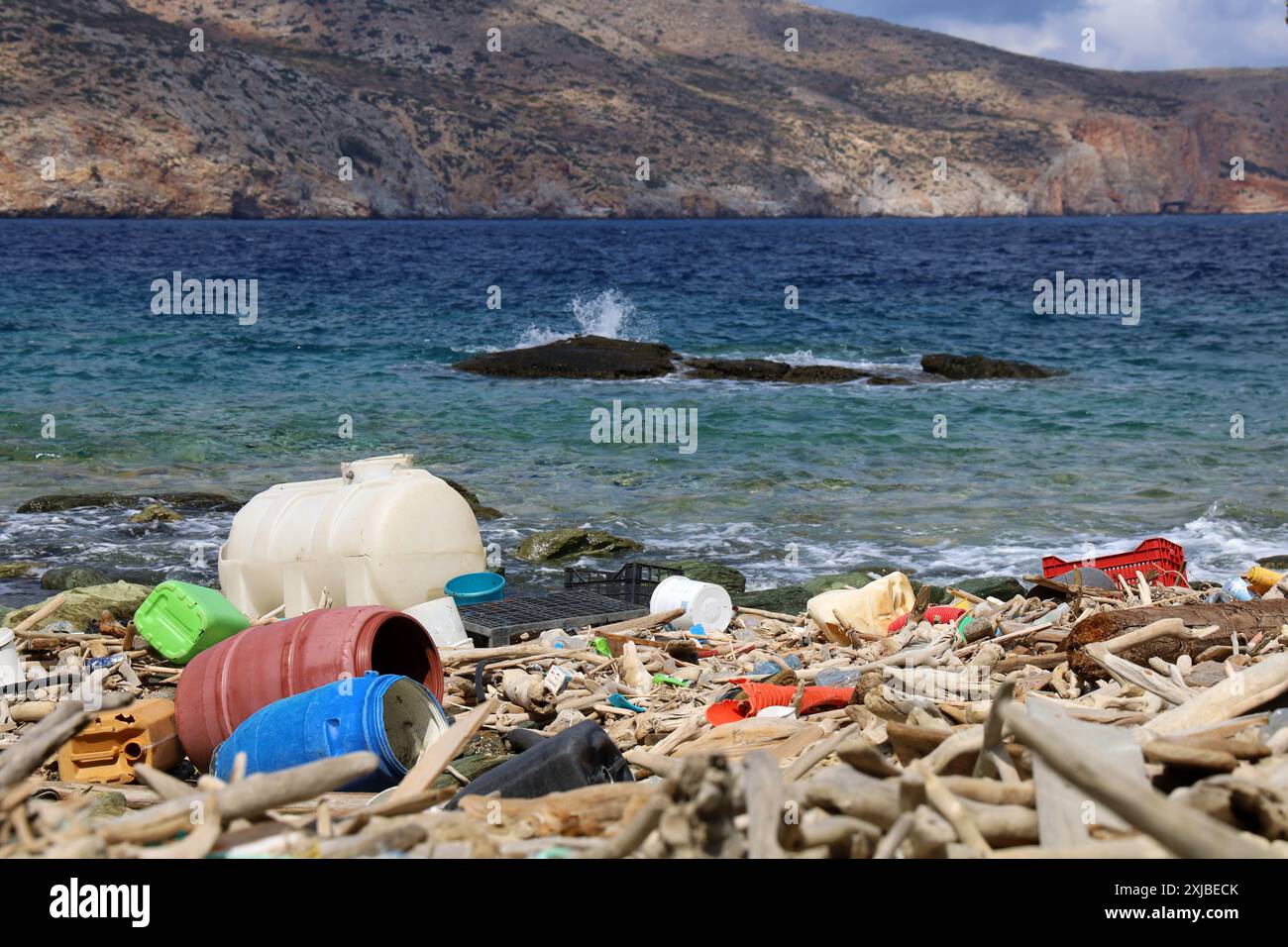 close up of stranded plastic trash between driftwood on the south coast ...