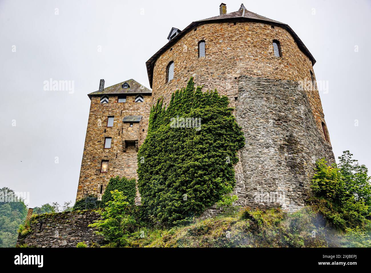 Round and square stone tower with multiple windows at Reinhardstein ...