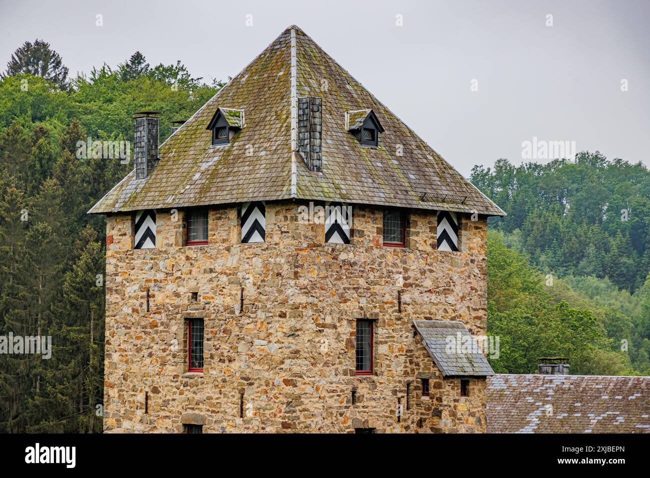 Square tower with its stone walls, multiple windows and hipped roof at ...