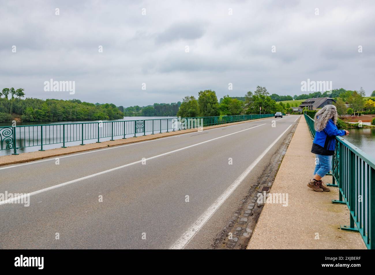 Vehicular bridge over Lake Robertville, car driving, senior adult woman ...