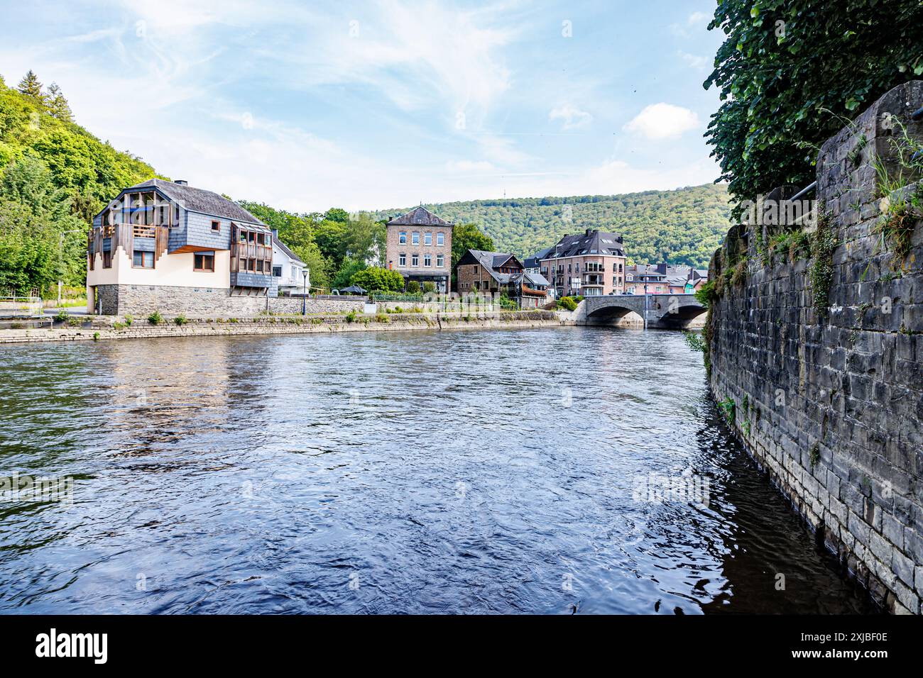 River Ourthe between brick walls of pedestrian promenade along river ...