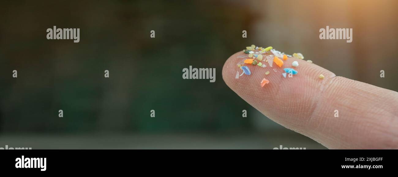 Macro shot of microplastics on a human finger. Concept of plastic waste ...