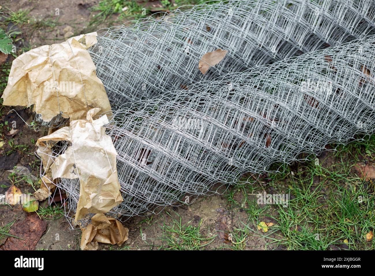 Galvanized metal mesh netting in rolls on the grass. Construction ...