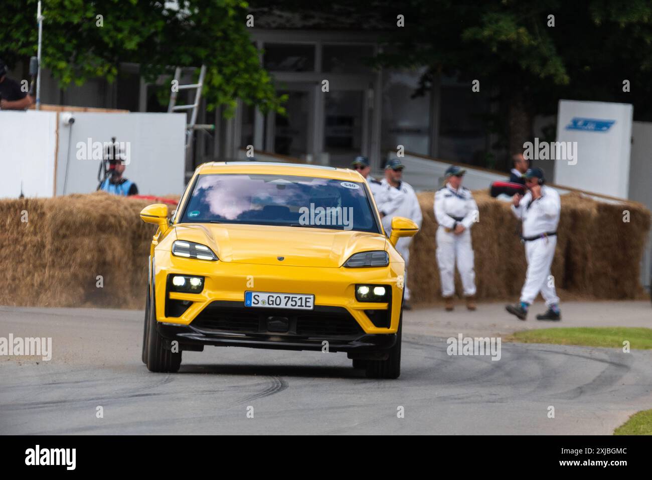 2024 Porsche Macan Turbo car driving up the hill climb track at the ...