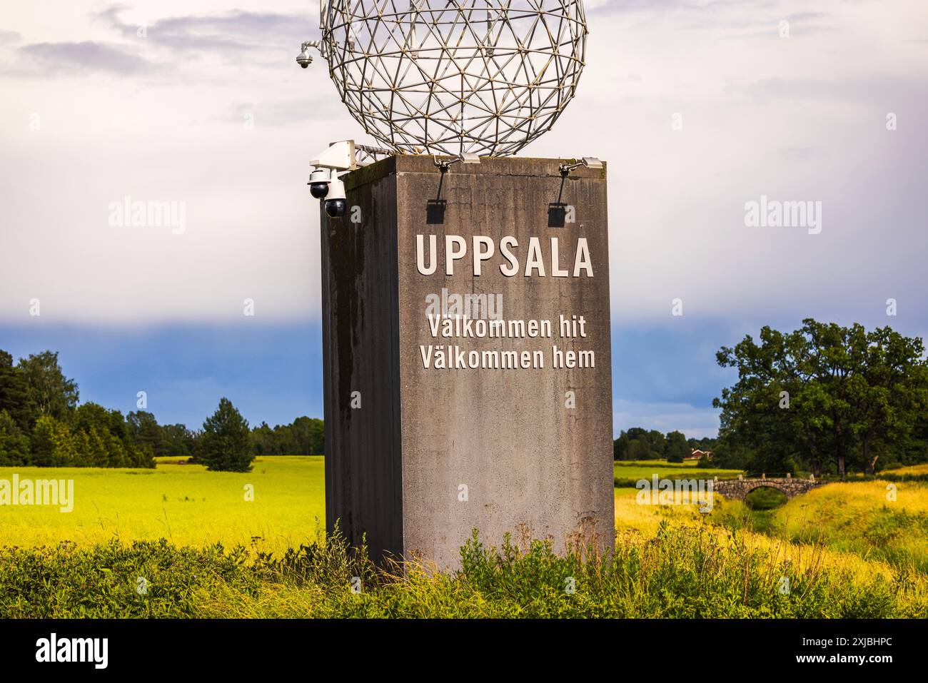 Uppsala welcome sign in Swedish countryside with green fields and trees ...