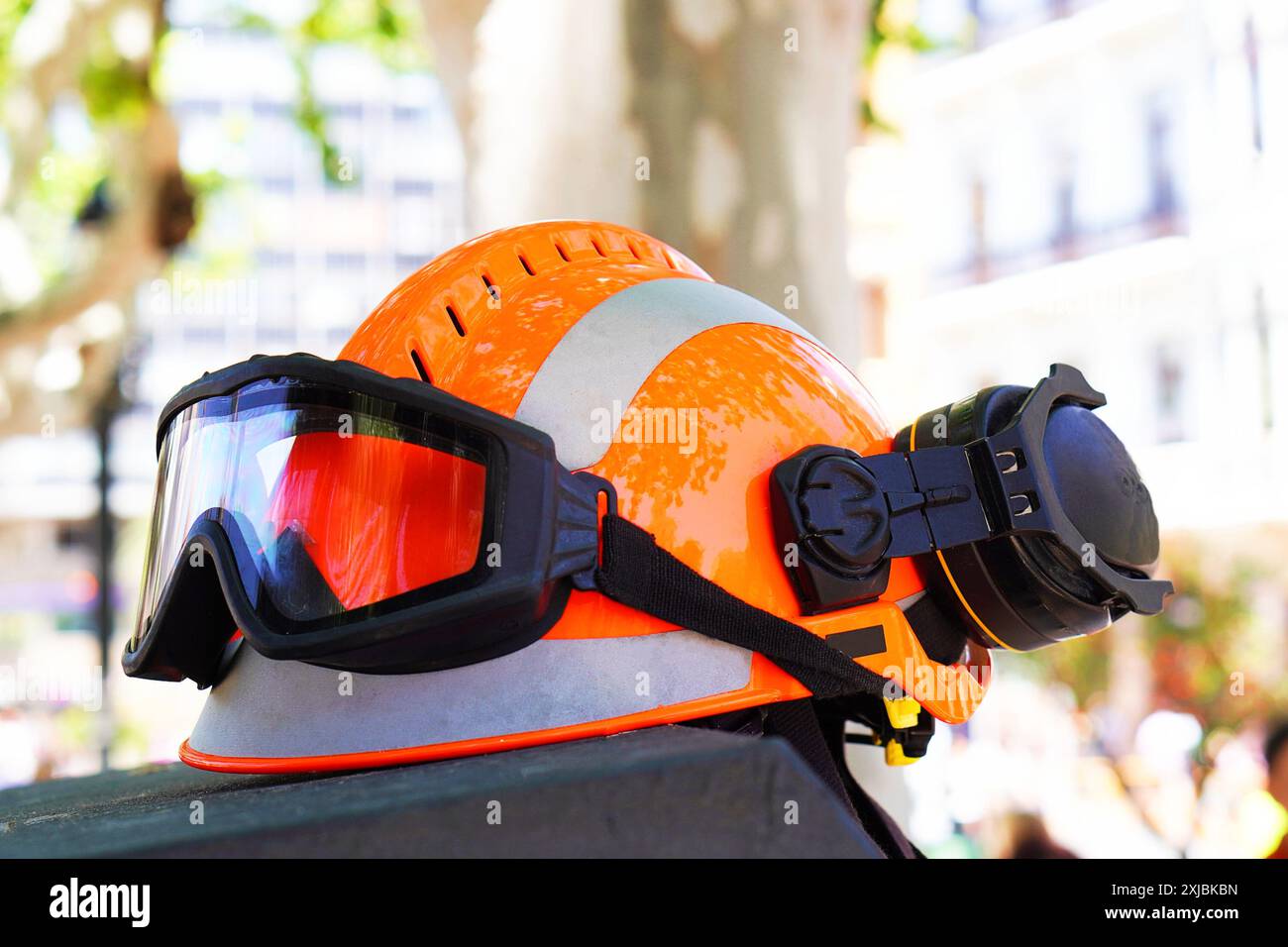 orange safety helmet equipped with goggles and headphones for sound ...