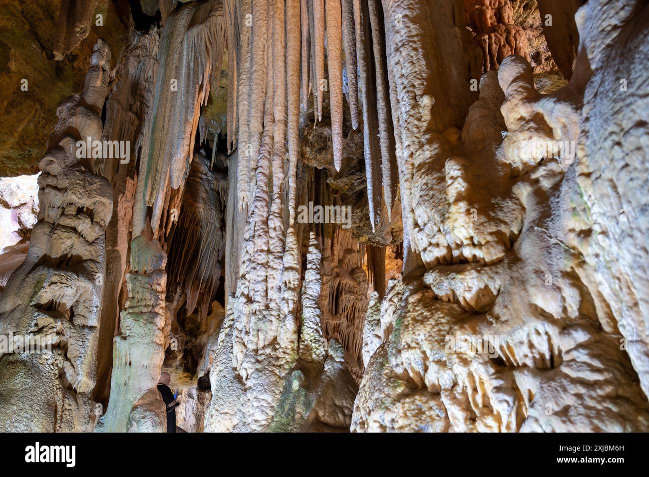 A detailed view of stalactites in a cave, characterized by elongated ...