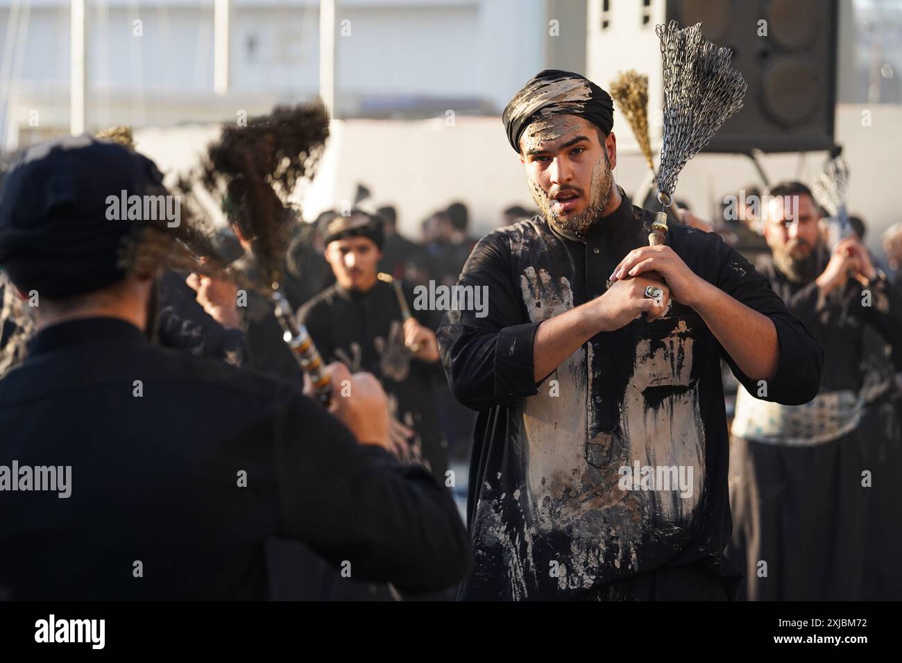 An Iraqi Shiite Muslim man flogs himself with chains while ...