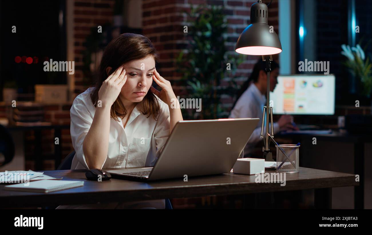 Tired employee struggling to remain focused at workspace desk, feeling ...