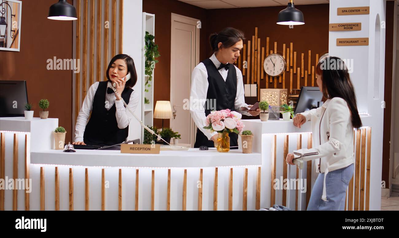 Employee looking at passport info for guest identification, undergoing ...