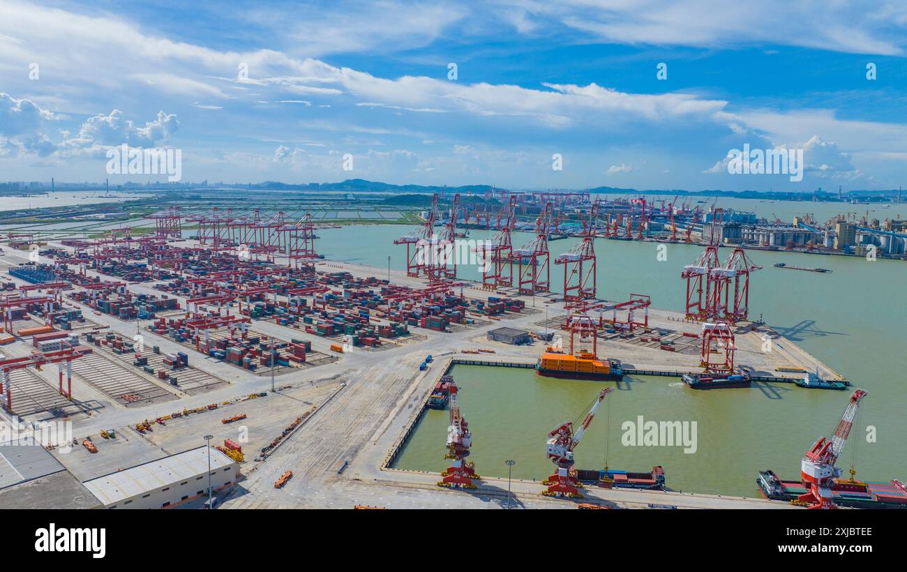 GUANGZHOU, CHINA - JULY 13, 2024 - Cargo ships load and unload cargo at ...
