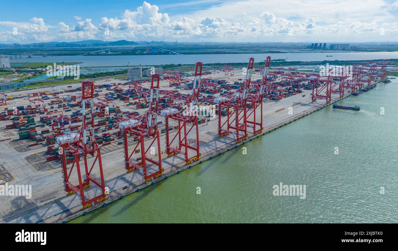 GUANGZHOU, CHINA - JULY 13, 2024 - Cargo ships load and unload cargo at ...