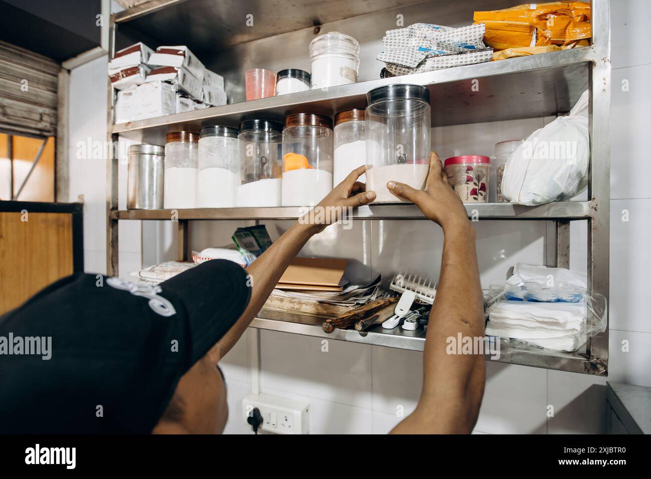 Organized kitchen shelf with jars and containers for efficient storage ...