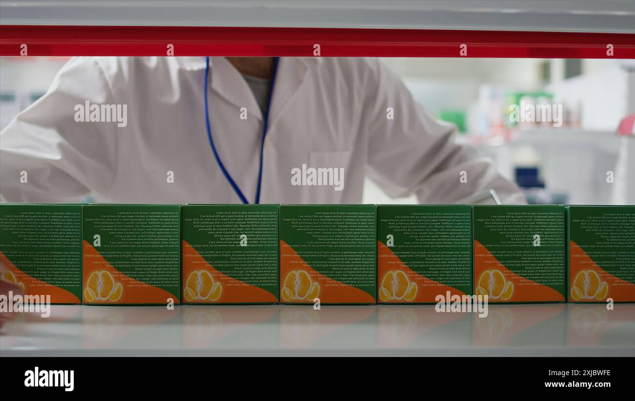 Pharmacy worker emptying shelves for stock reorganization, putting all ...