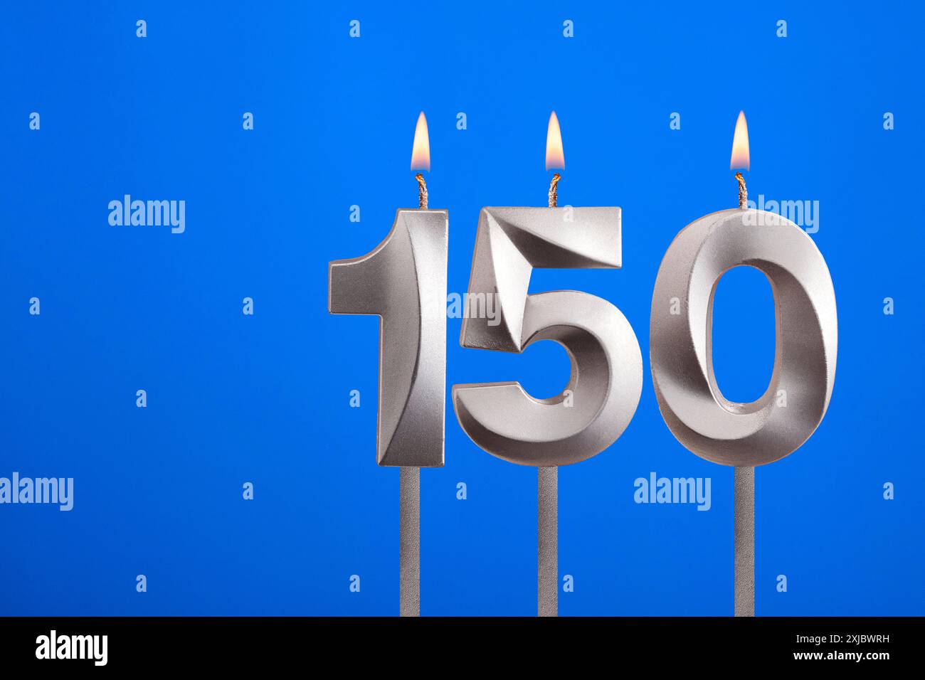 Birthday number 150 - Candle lit on blue background Stock Photo - Alamy