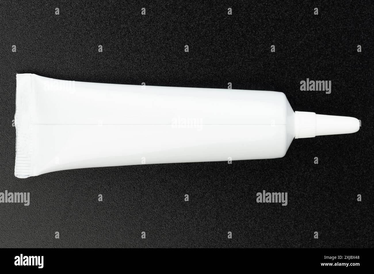 White plastic cream tube isolated on black studio background Stock ...